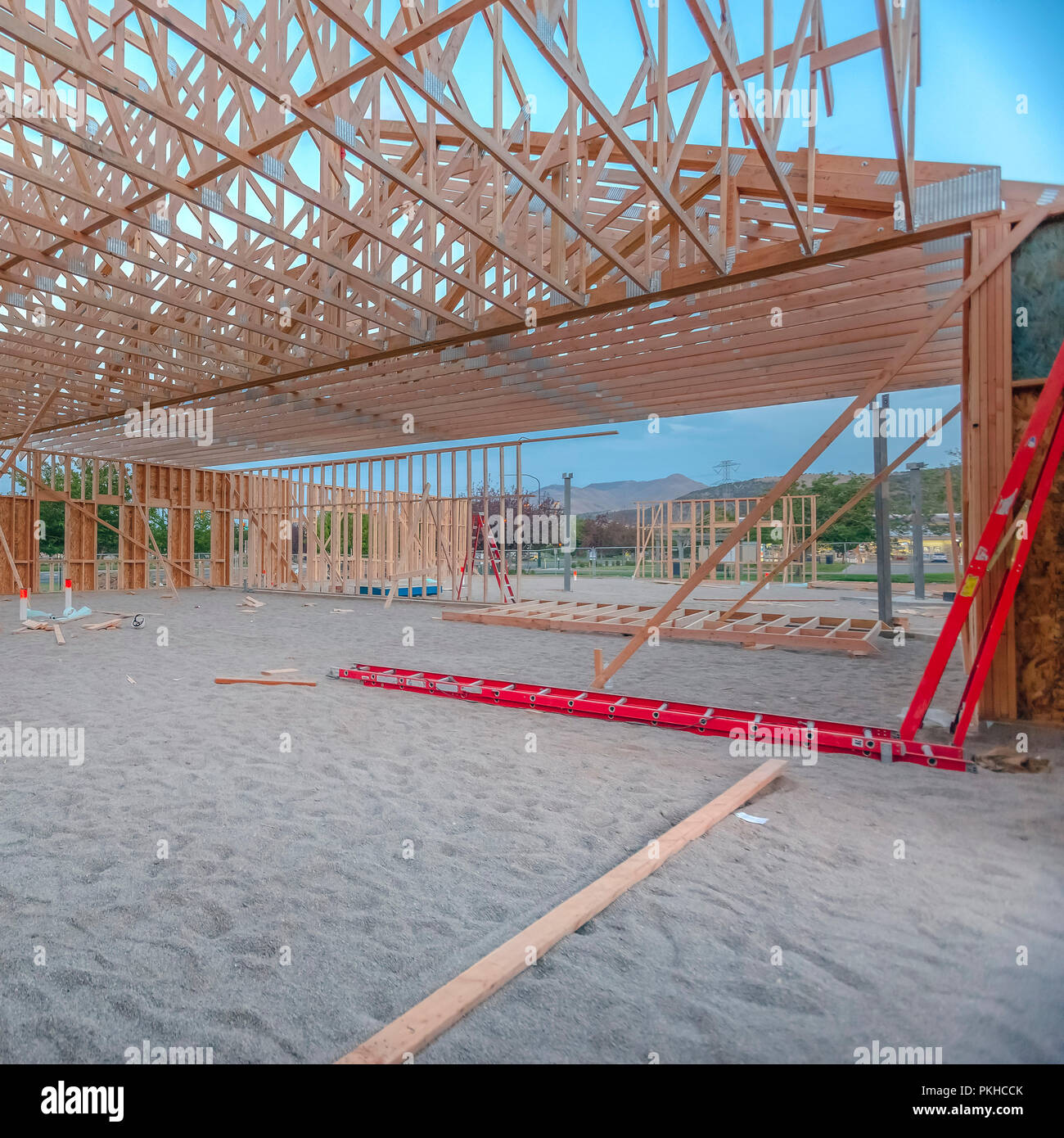 Wooden beams and red ladders yard square Stock Photo - Alamy