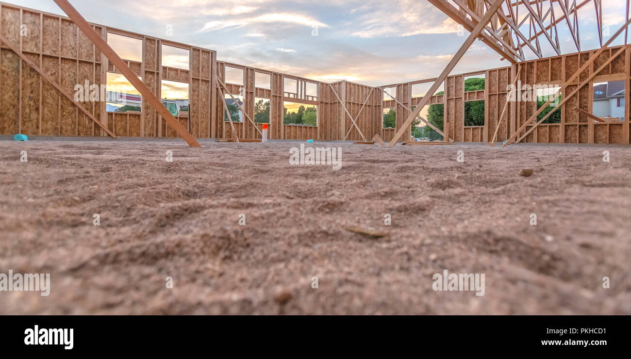 Wooden beams and sand area in building pano Stock Photo - Alamy