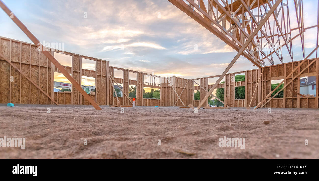 Wooden beams in sand area in building wide pano Stock Photo - Alamy