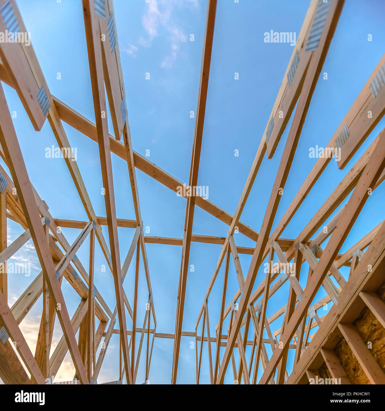 Wooden roof in a building being built square Stock Photo - Alamy
