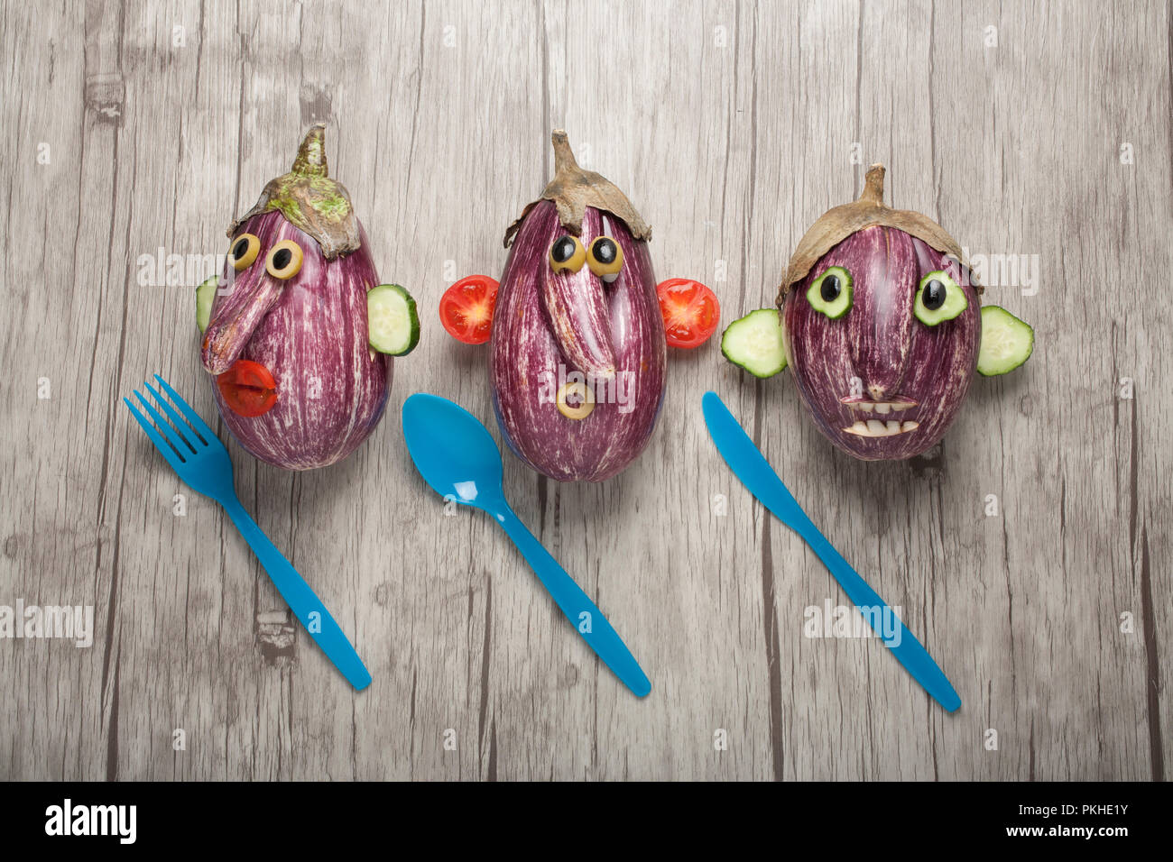 Funny faces made with fresh vegetables on board Stock Photo - Alamy