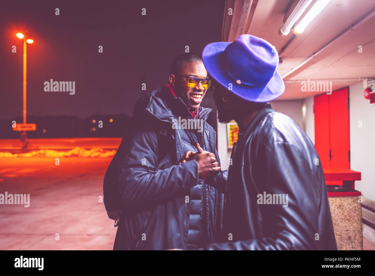two young men outdoors parking lot greetings - gestures, swag, crew ...