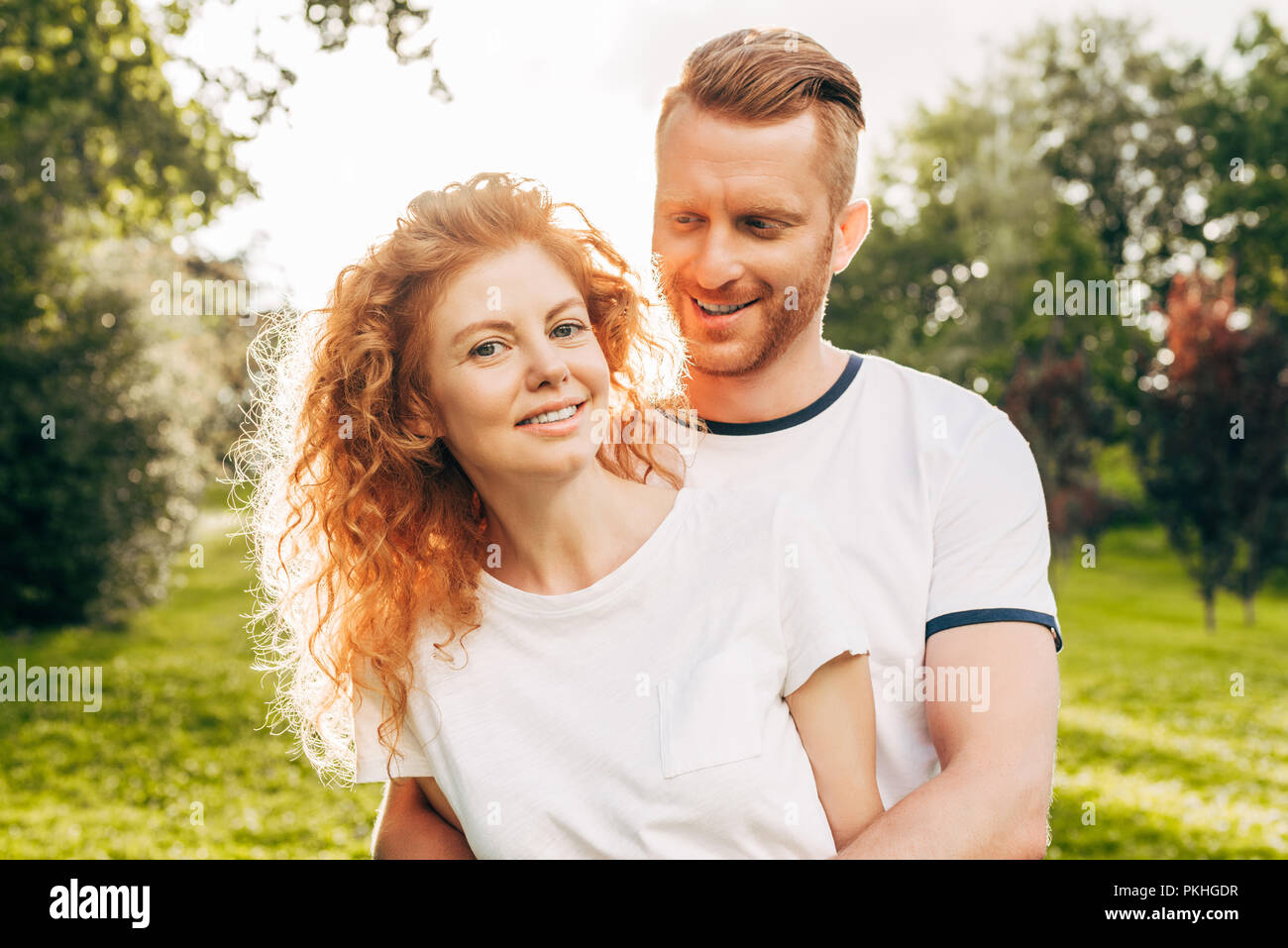 beautiful happy redhead couple spending time together in park Stock ...