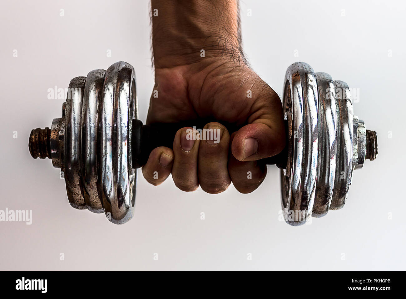 Hand holding heavy dumbbells to exercise Stock Photo - Alamy