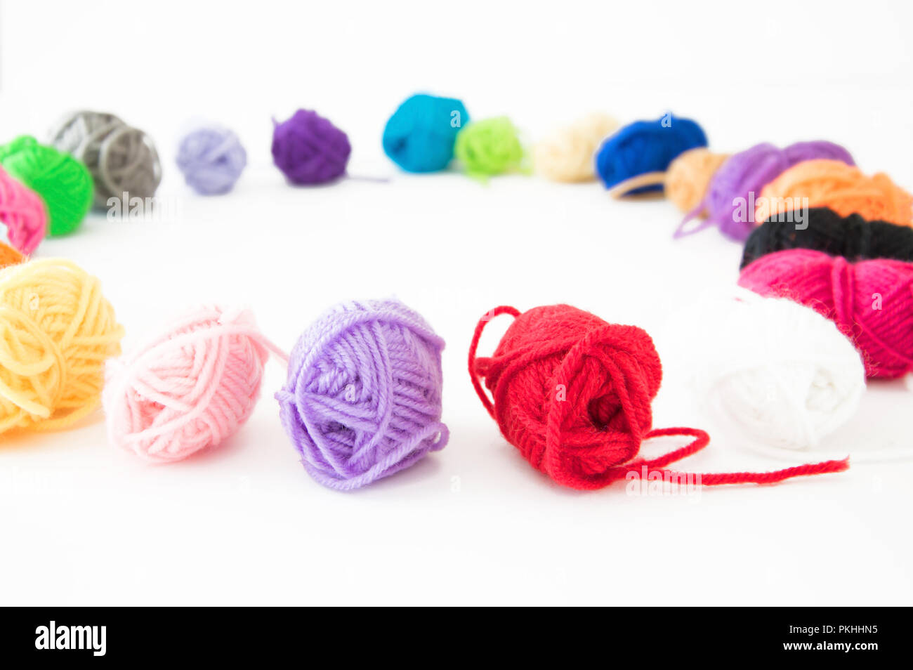 Colored yarn balls in a circle on a white background Stock Photo - Alamy