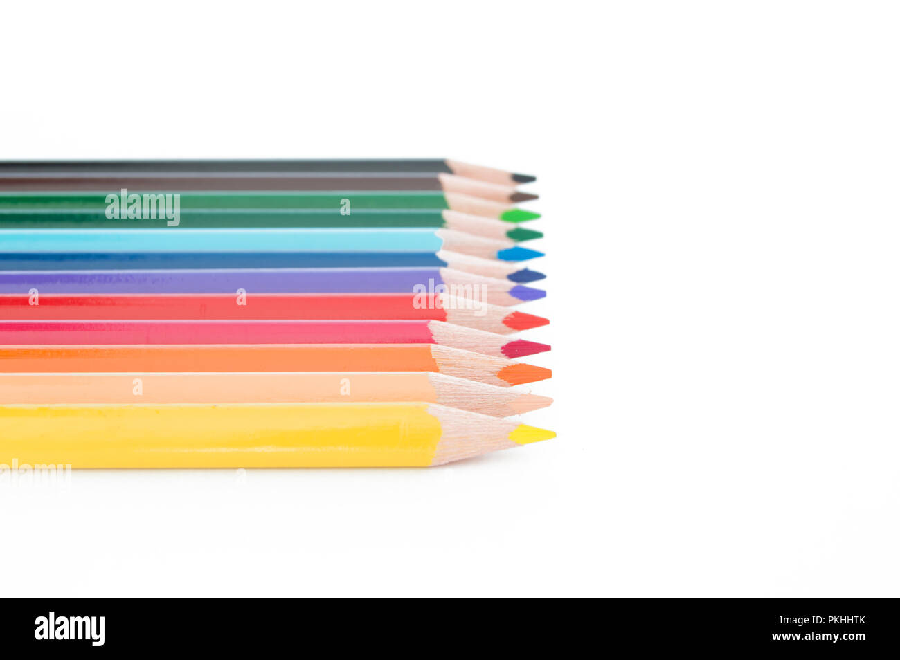 A row of colored pencils from the side on a white background Stock ...