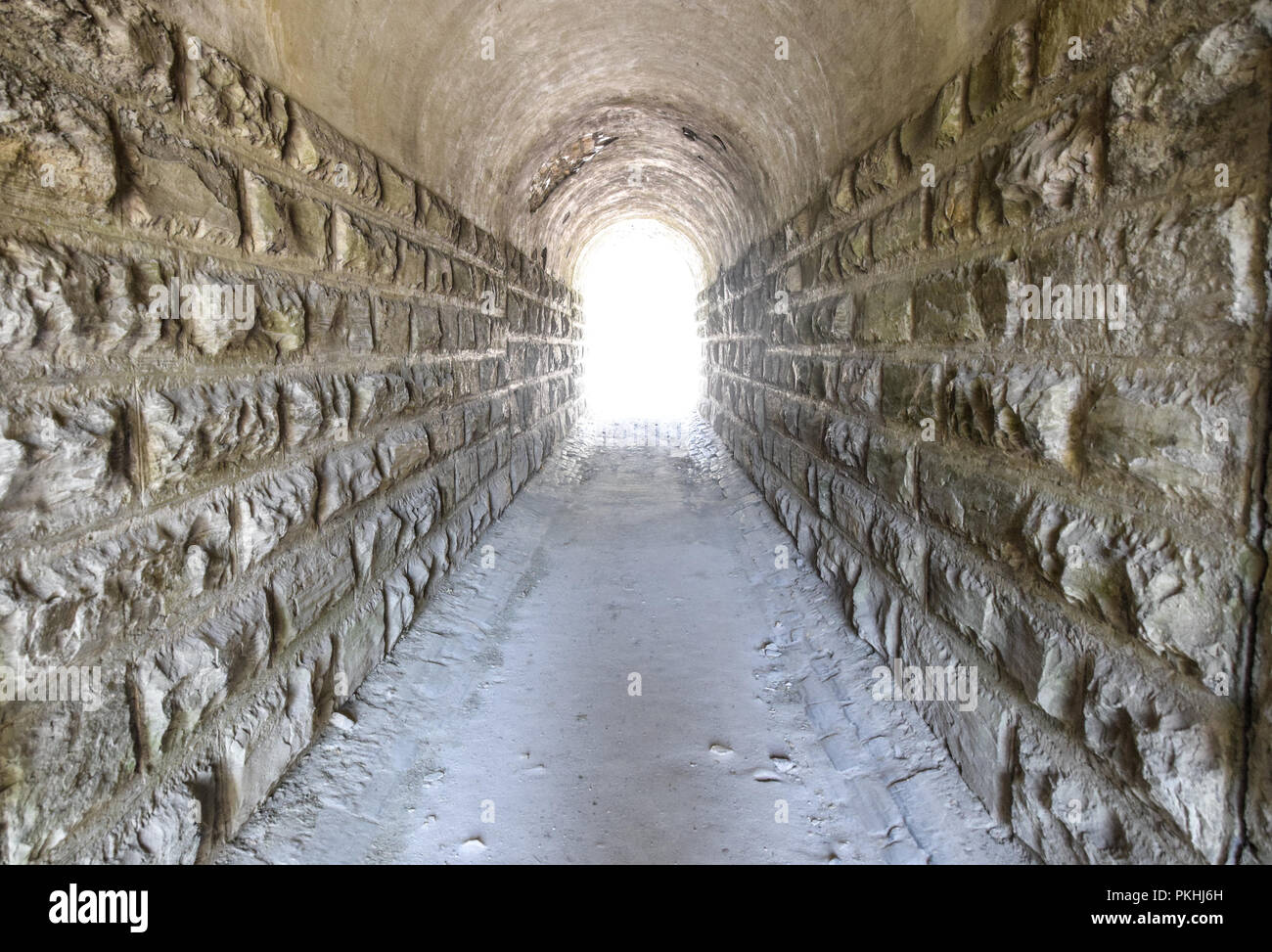 A light in the end of a tunnel. Passage under the railway Stock Photo ...