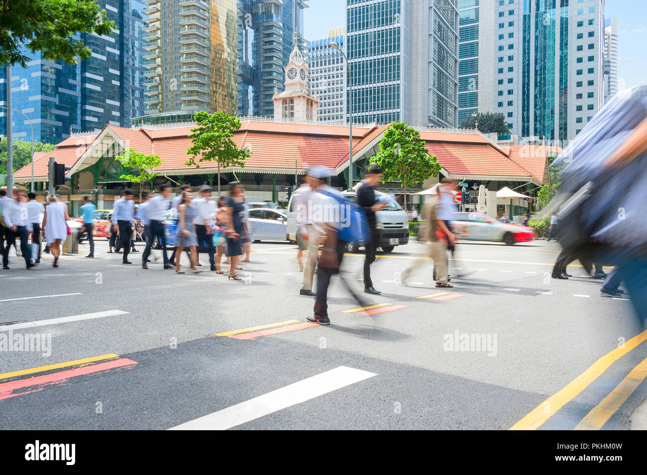 People walking by crossroad during rush hour in business center of ...