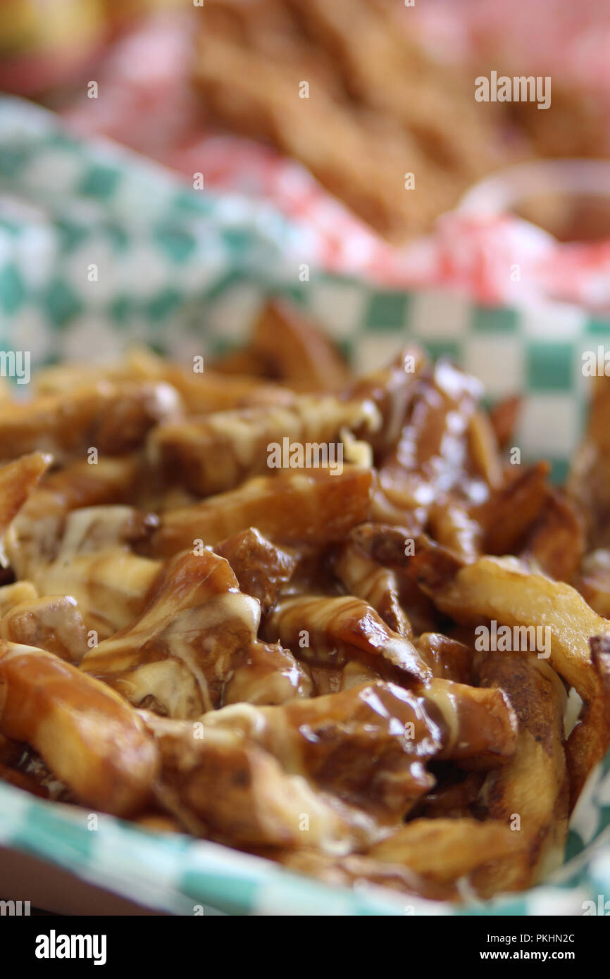 Fast food take out of Canadian poutine with cheese melting over French ...