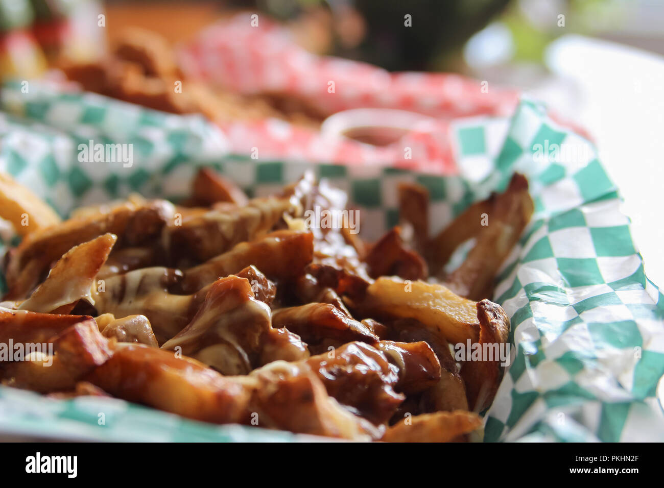 Fast food take out of Canadian poutine with cheese melting over French ...