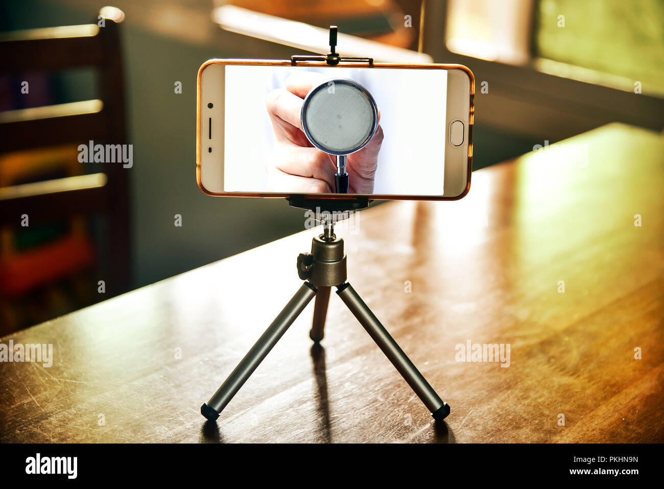 Doctor checkup in smartphone on a tripod in living room Stock Photo - Alamy