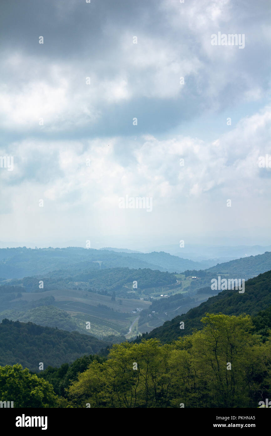 A view from a mountain down into a valley Stock Photo - Alamy