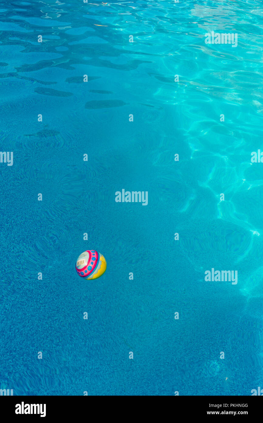 Plastic colored ball falling into a pool Stock Photo - Alamy