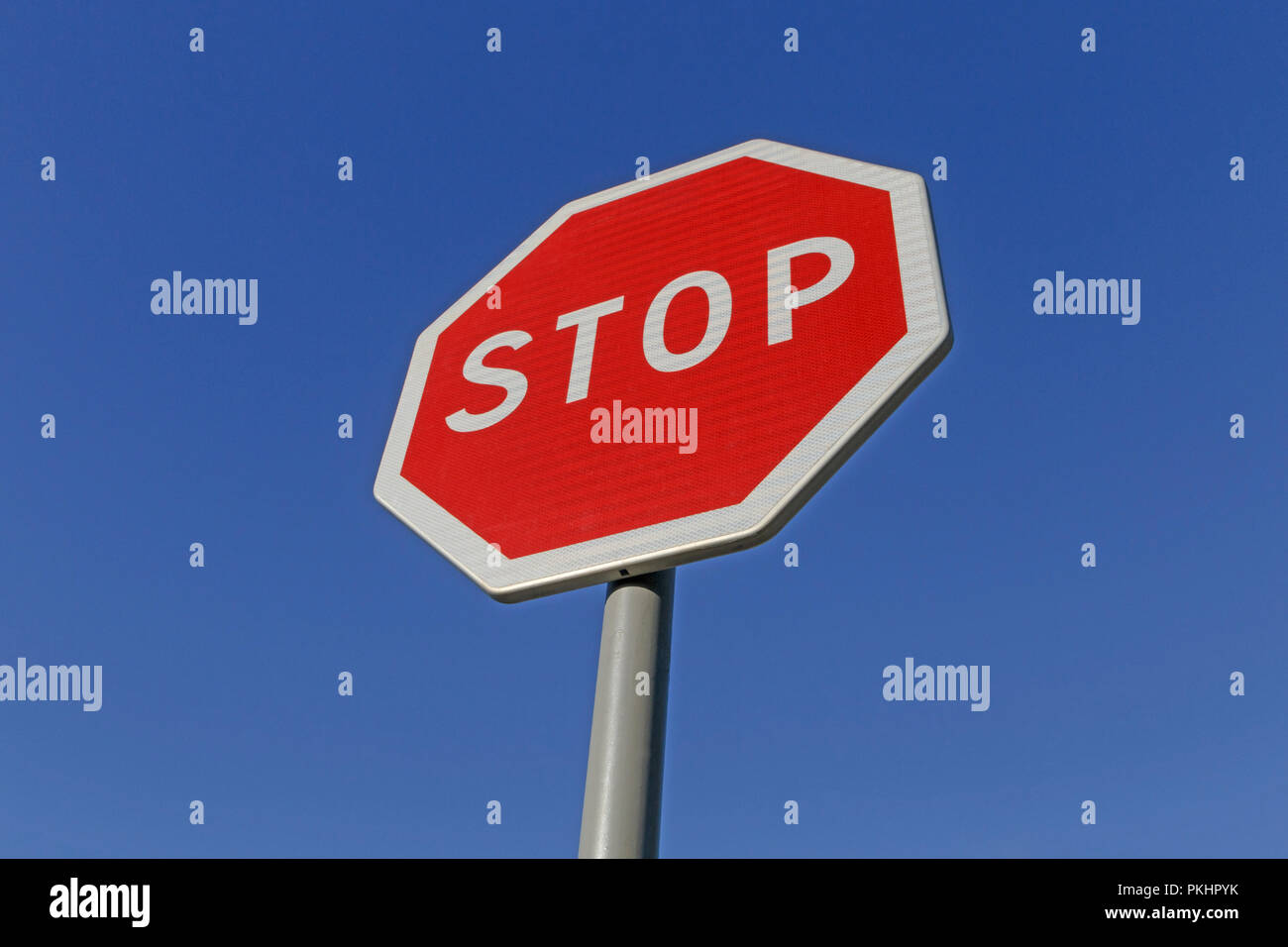 road sign stop on post against blue sky Stock Photo - Alamy
