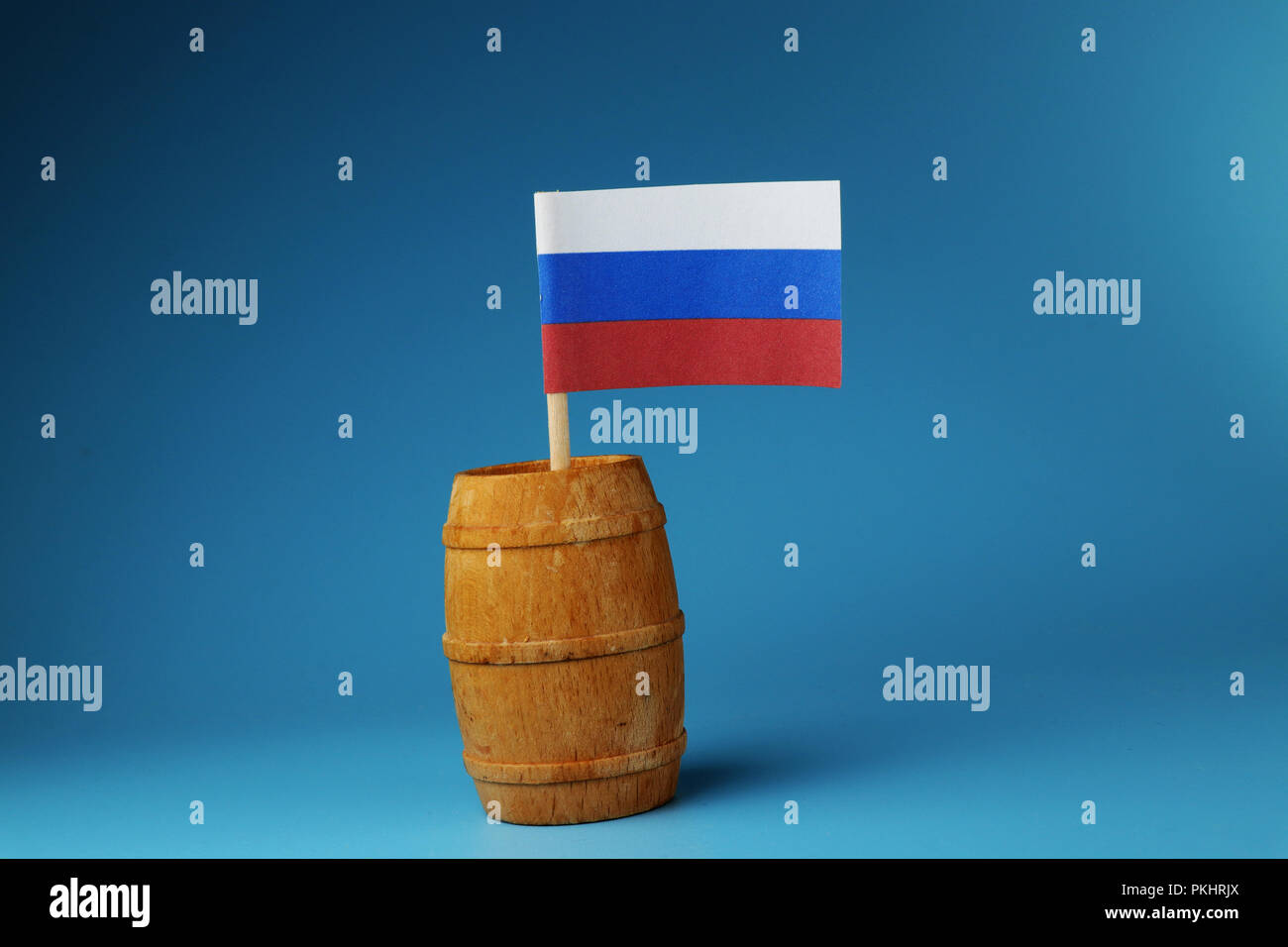 A national flag of Russia on wooden stick in wooden barrel on blue ...