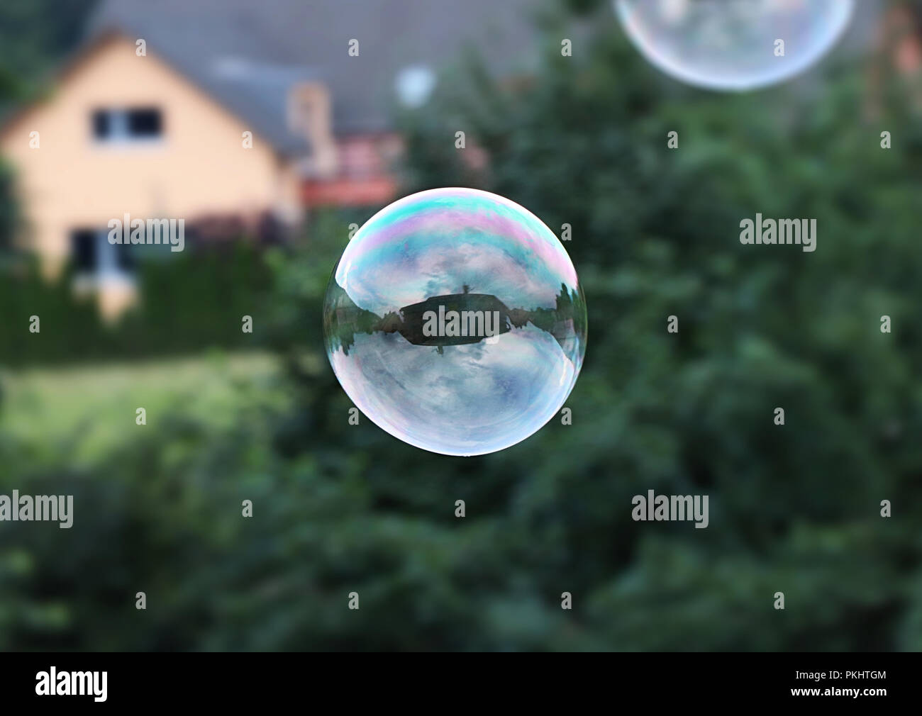 A one big bubble flying in the air. Bubble serve as mirror so we can ...