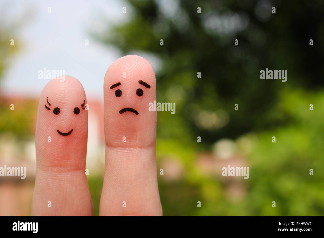 Finger art of couple. Woman is cheerful, man is sad Stock Photo - Alamy