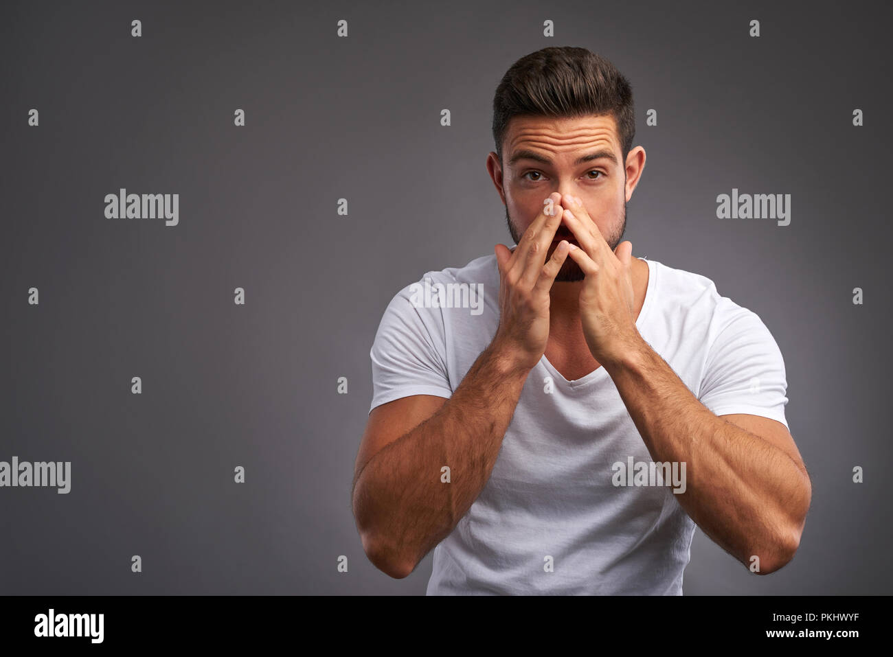 A handsome young man checking the skin on his face Stock Photo - Alamy