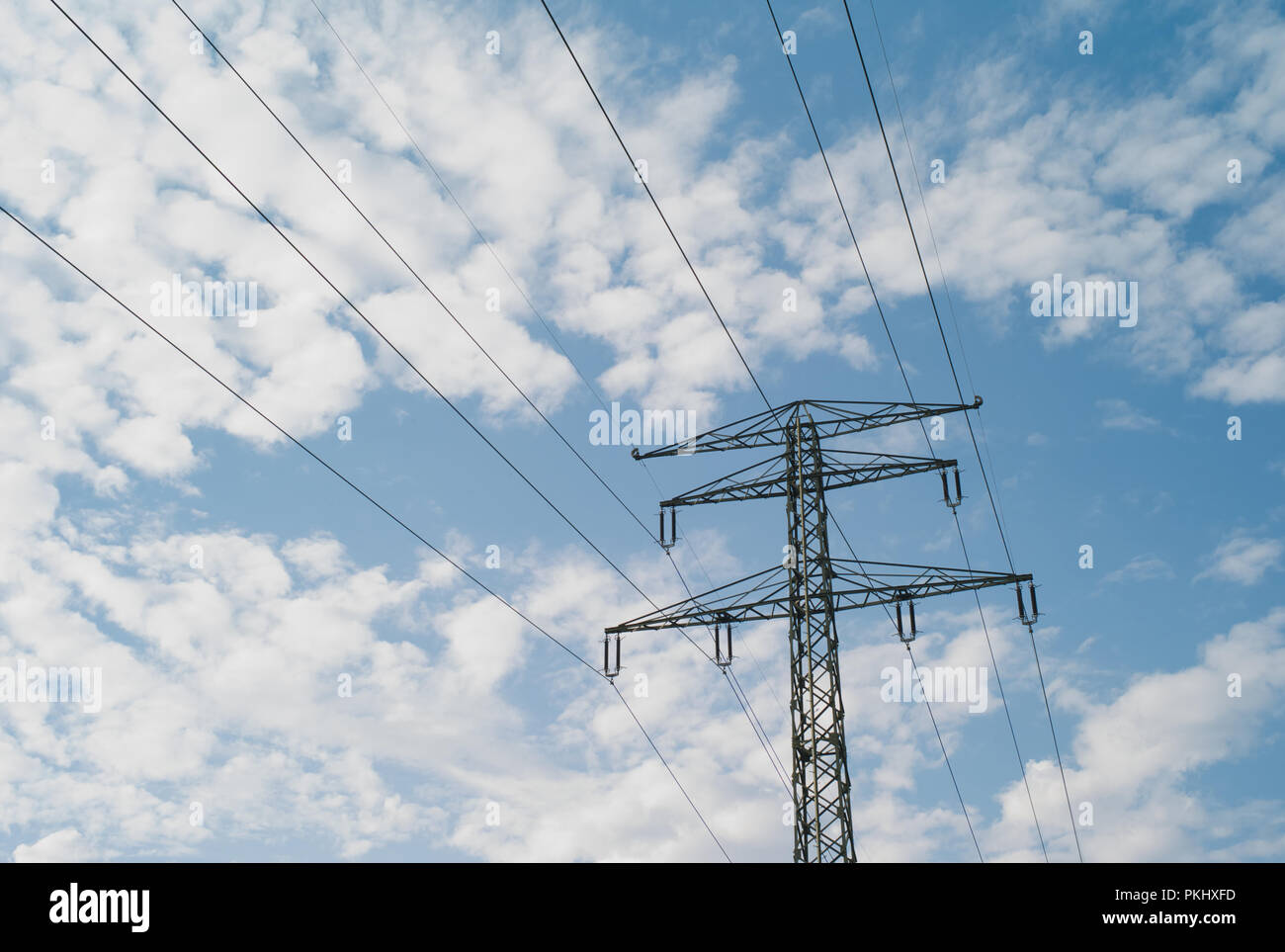 110 kV High Voltage Pylon on a Blue Sky Dotted with Clouds - Two Ground ...
