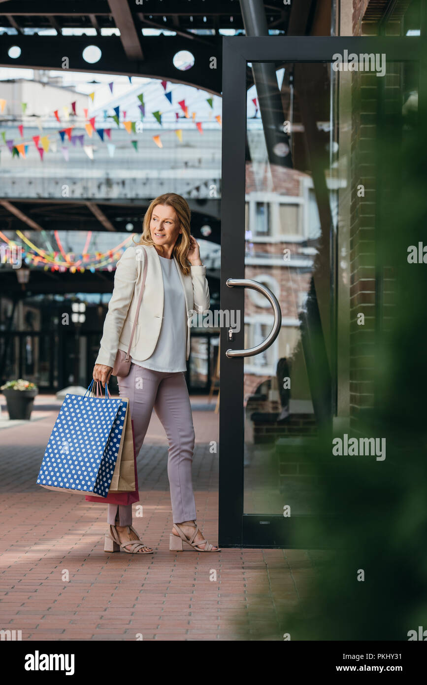Woman entering shopping mall hi-res stock photography and images - Alamy