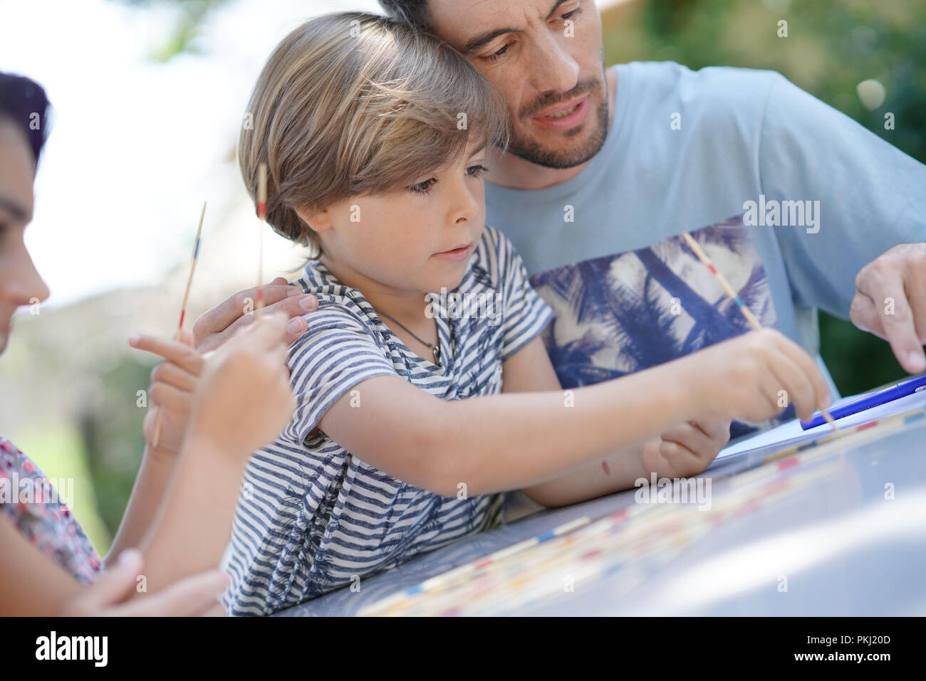 Happy family enjoying playing game together Stock Photo - Alamy