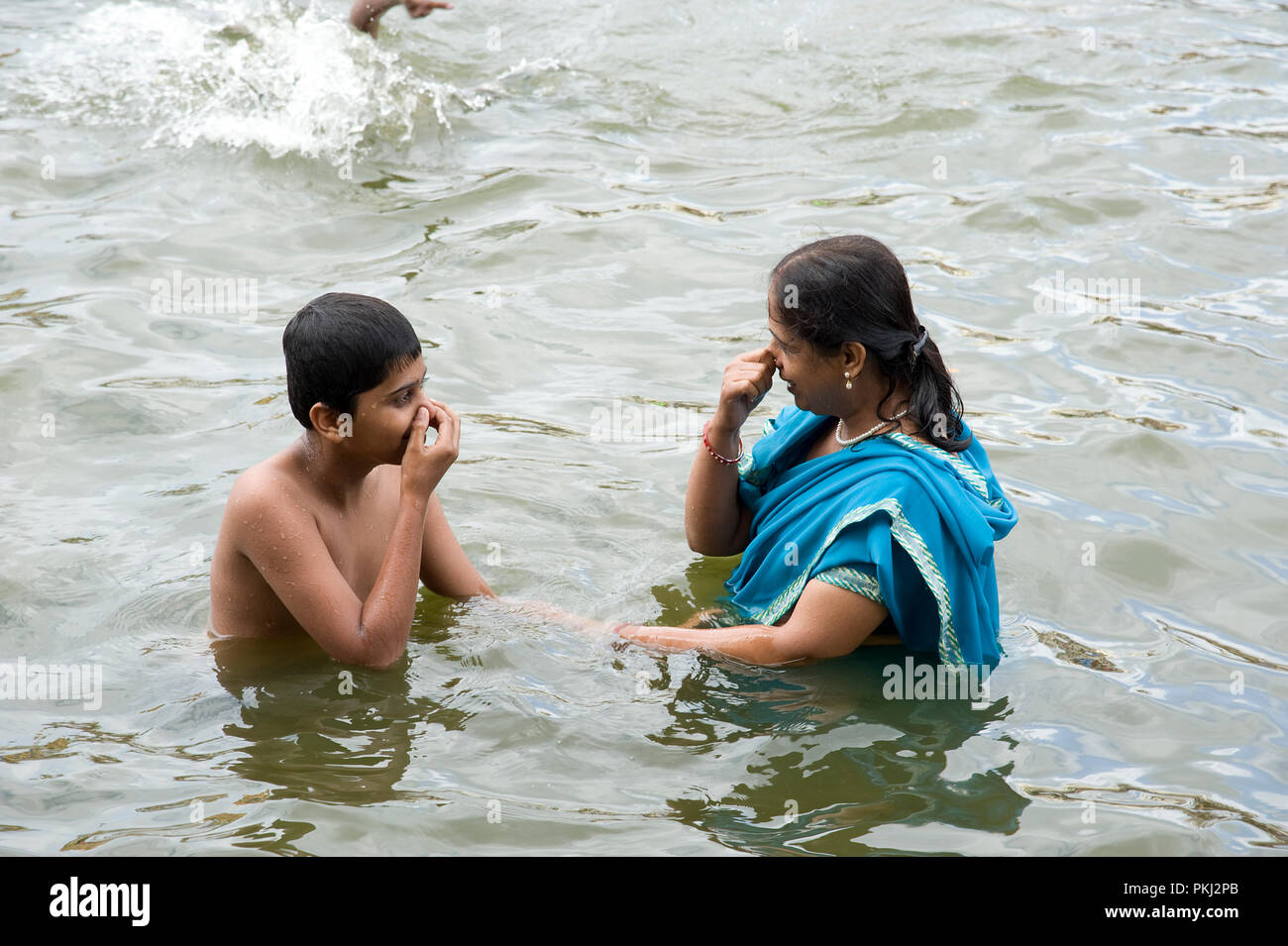 Hindu mother and child pilgrims Take Holy Dip at nashik kumbha mela ...