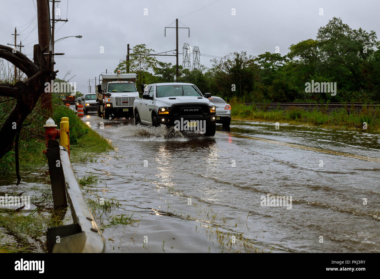 Car traffic in a heavy rain on a flooded road Stock Photo - Alamy