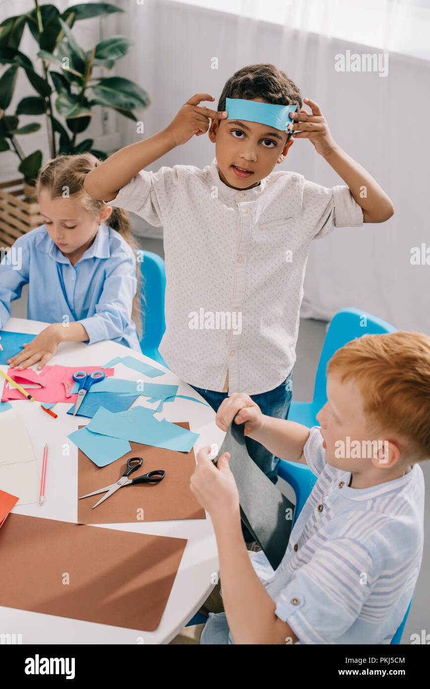adorable multiracial kids making paper applique in classroom Stock ...