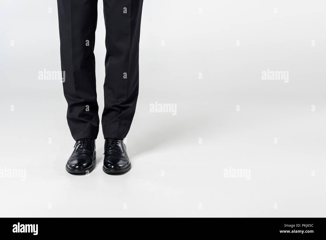 partial view of businessman in stylish clothing on grey background ...