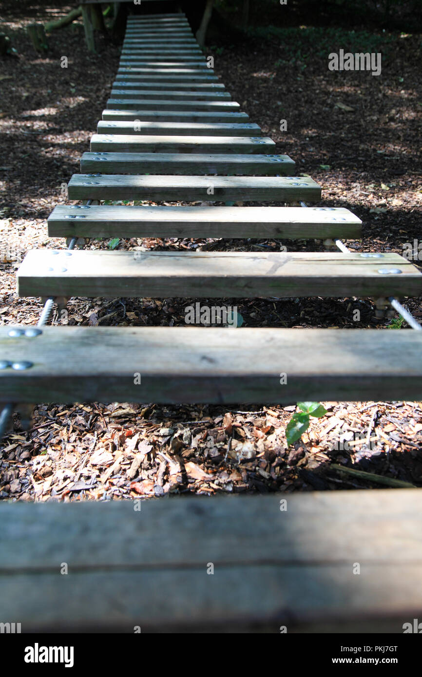 Wooden suspension bridge on children's playground Stock Photo - Alamy