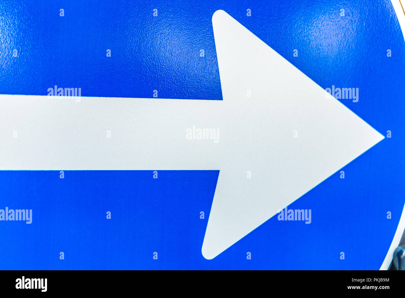 closeup of traffic arrow sign, white arrow on blue road sign Stock ...