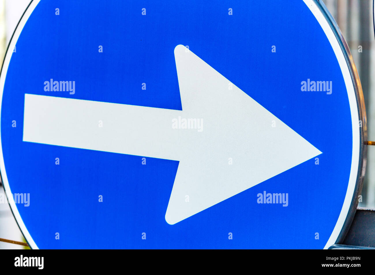 closeup of traffic arrow sign, white arrow on blue road sign Stock ...