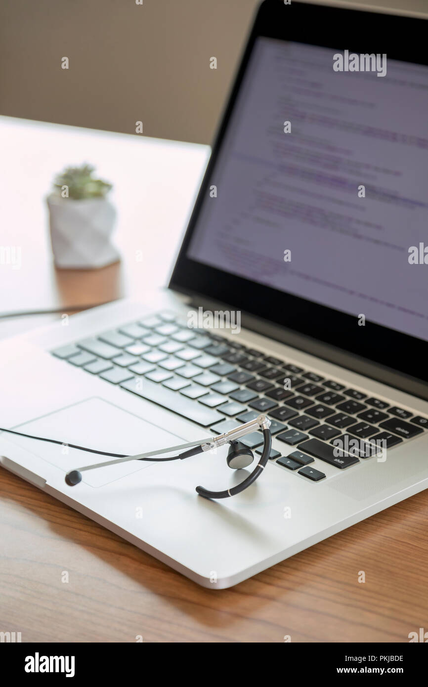 Laptop with headset Stock Photo - Alamy