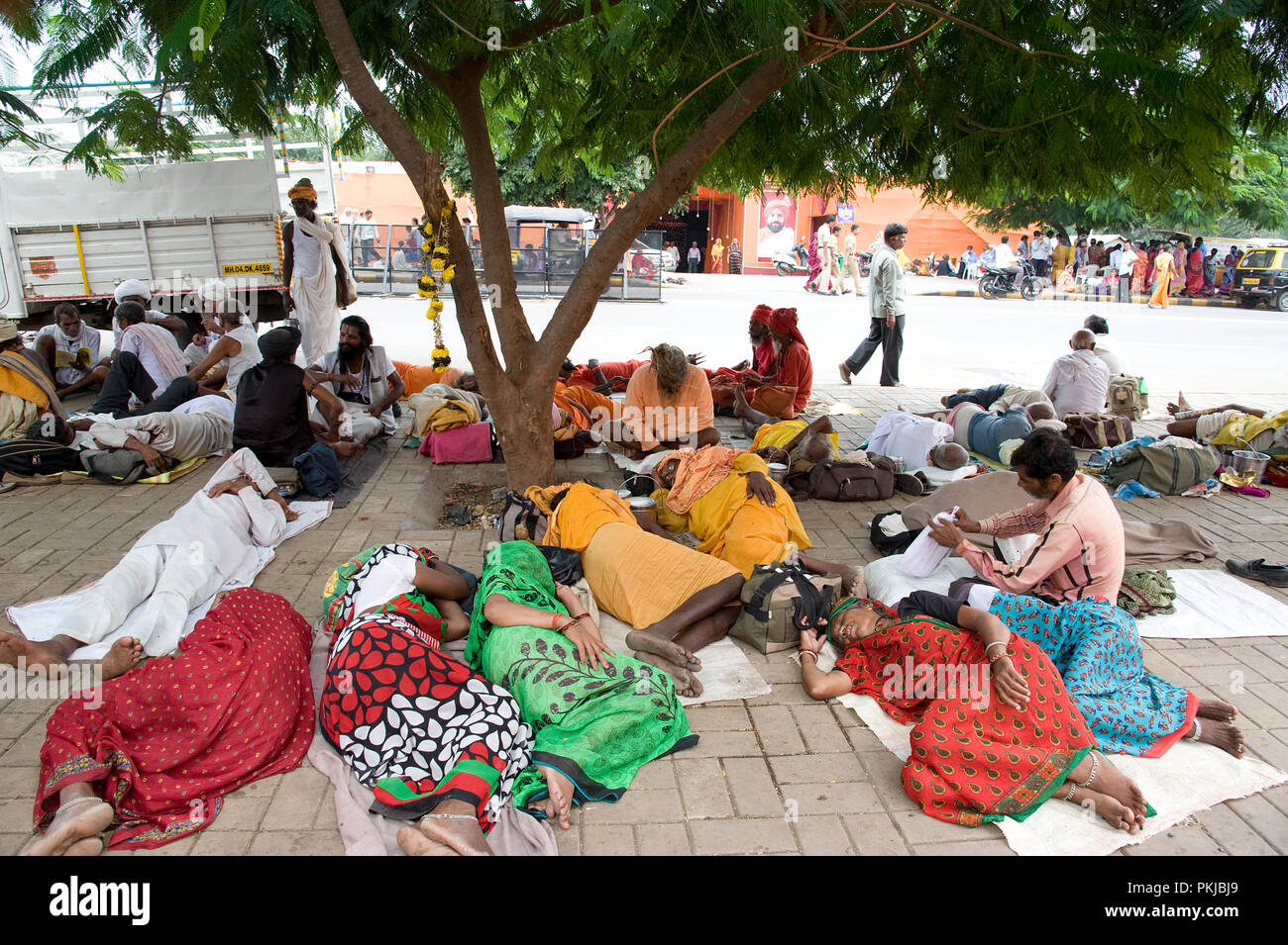 Hindu devotees sleeping under a tree at Panchavati ram kund in nashik ...