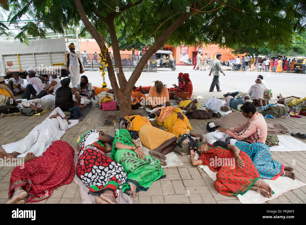 Hindu devotees sleeping under a tree at Panchavati ram kund in nashik ...