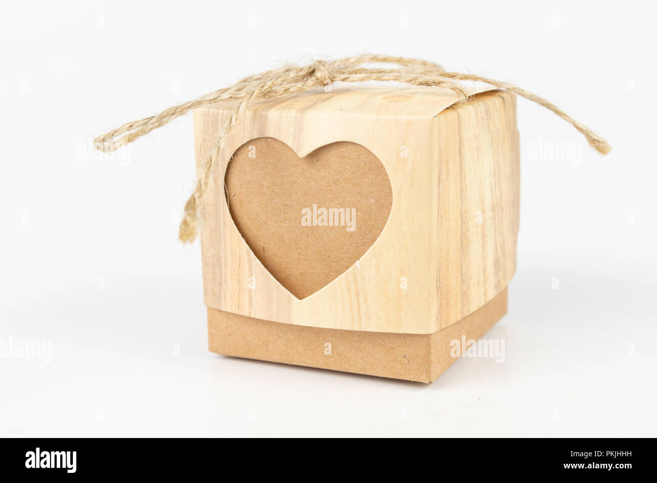 Boxes with the word love on a white table. A gift in a box with a heart ...