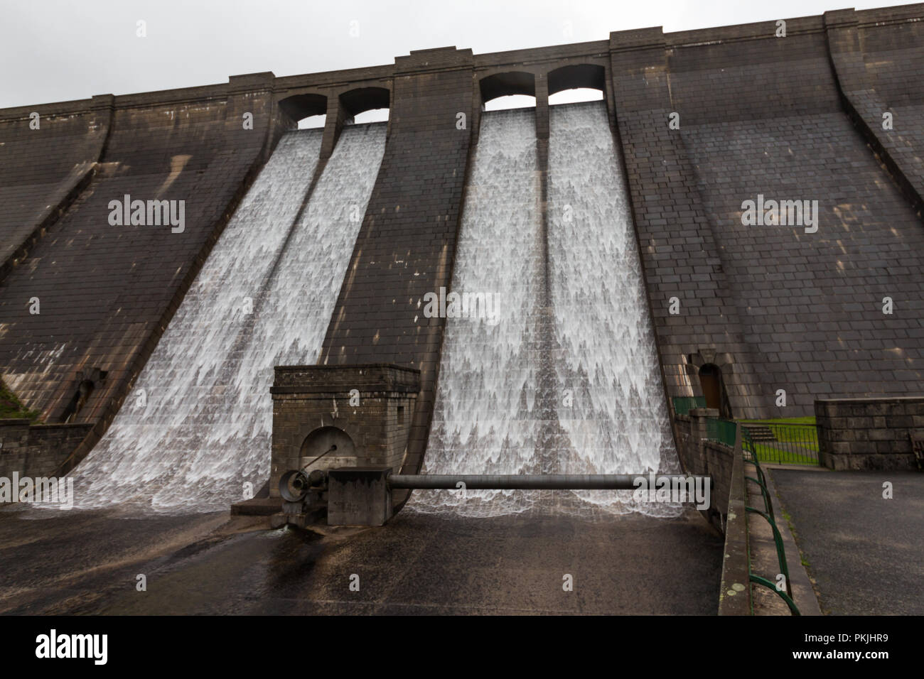 Water is cascading down the dam wall at Ben Crom Reservoir in the heart ...