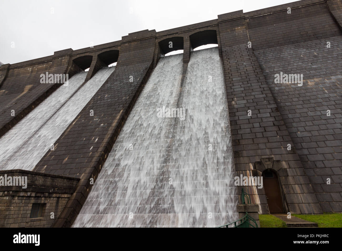 Water is cascading down the dam wall at Ben Crom Reservoir in the heart ...