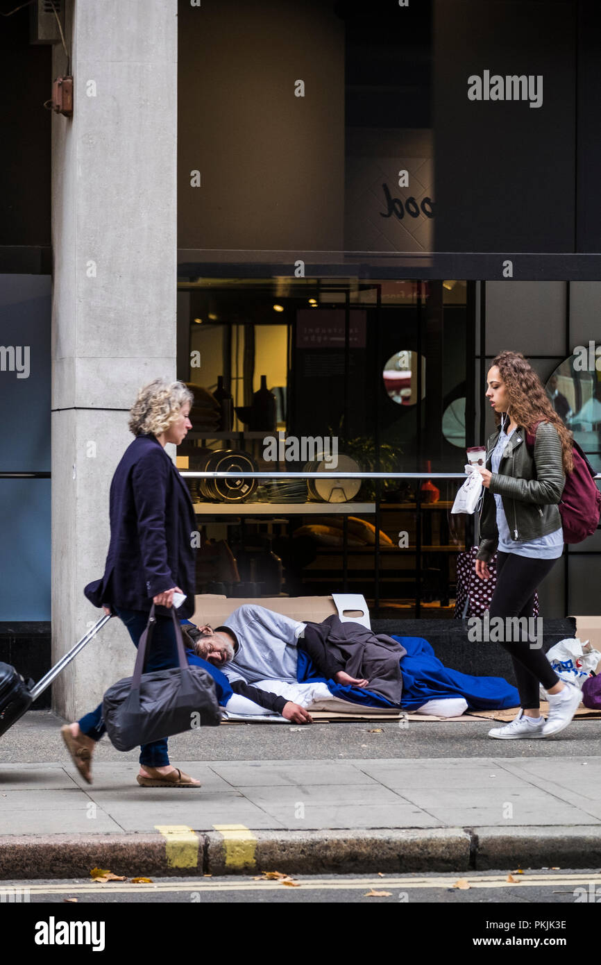 People walking past rough sleeper on the street in the Borough of ...
