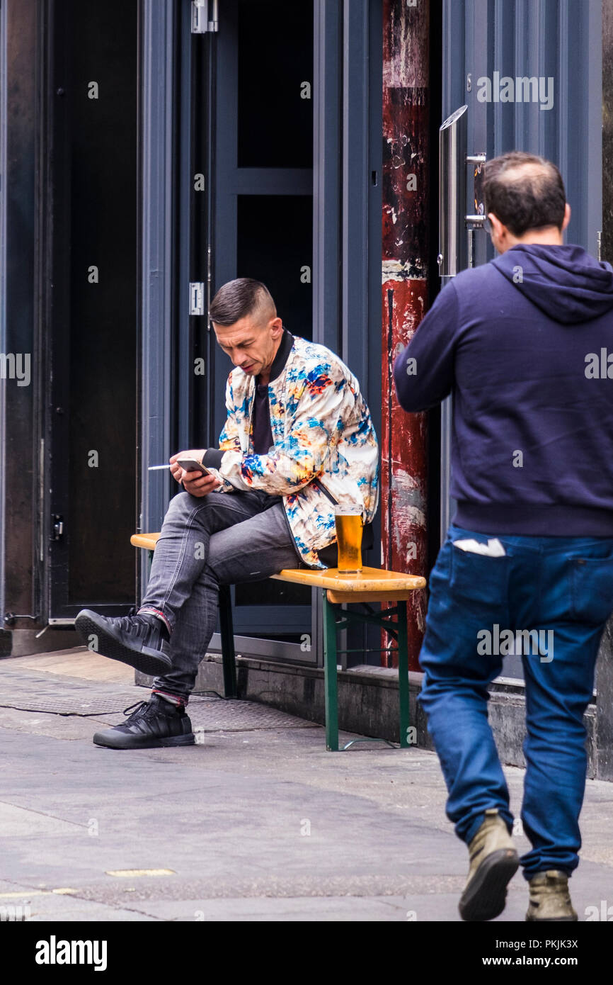 People using mobile devices out on the street, City of Westminster ...