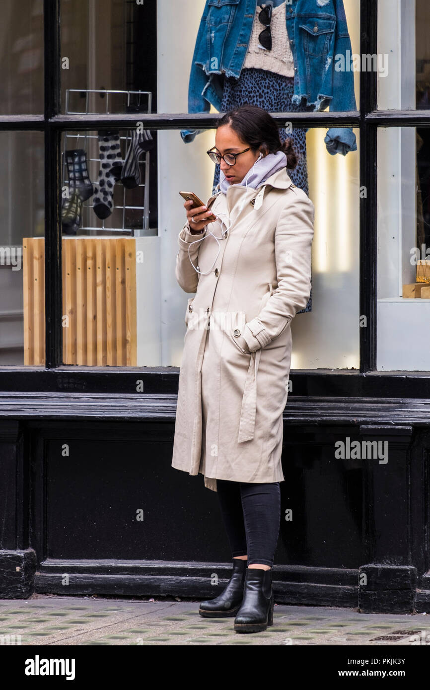 People using mobile devices out on the street, City of Westminster ...