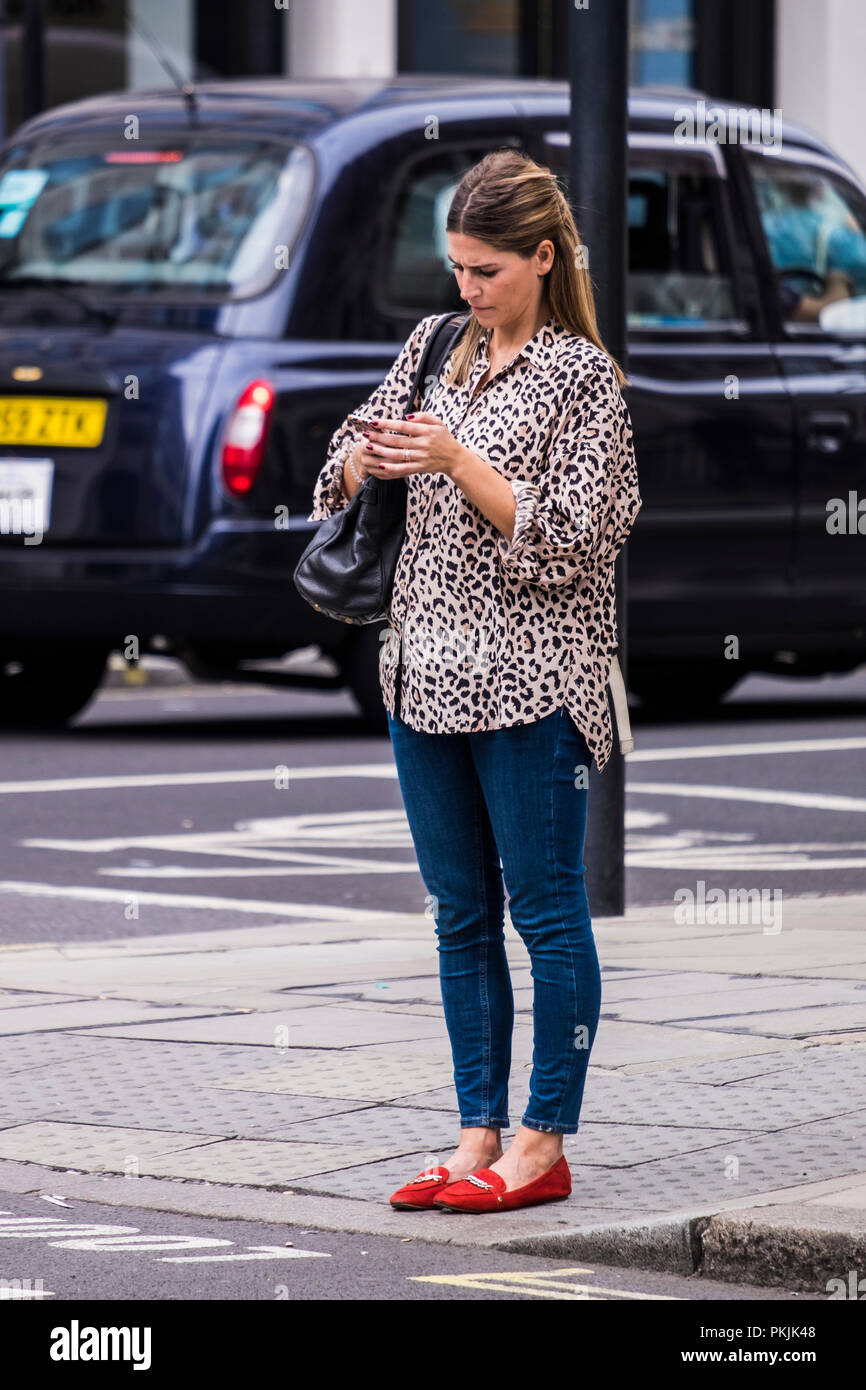 People using mobile devices out on the street, City of Westminster ...