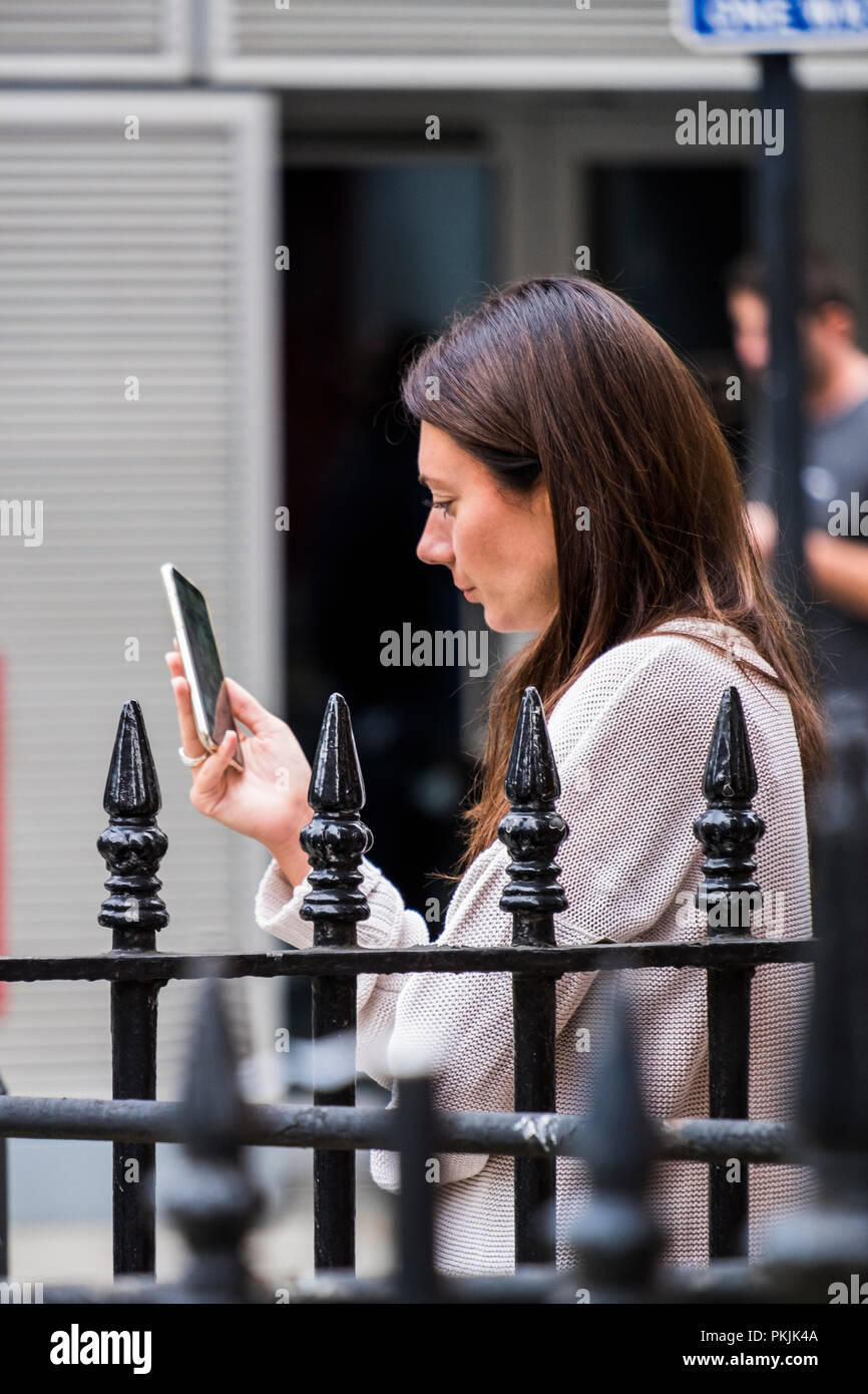 People using mobile devices out on the street, City of Westminster ...