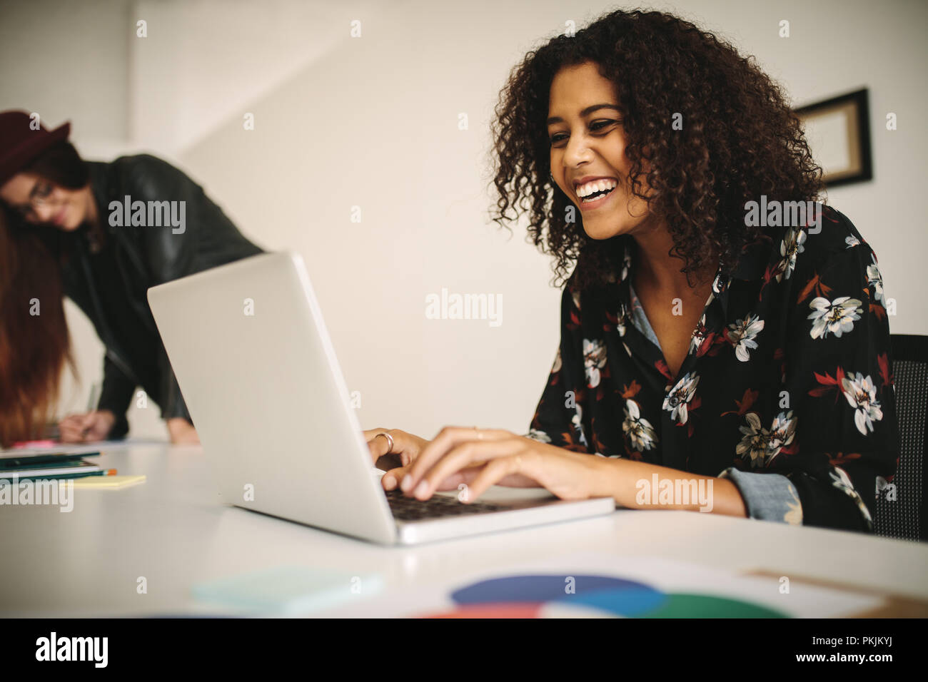 Smiling business colleagues working together in office. Businesswoman ... Smiling business colleagues working together in office. Businesswoman ...