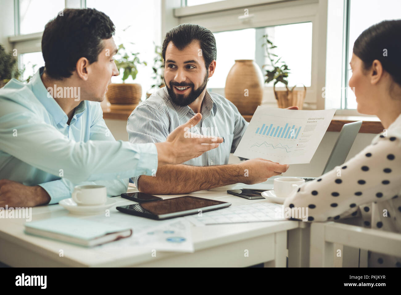 Smart young man pointing at the diagram Stock Photo - Alamy