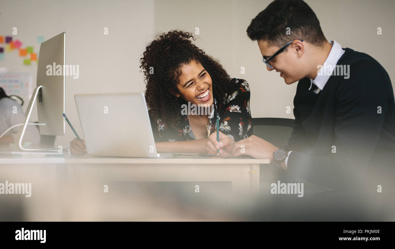 Businessman and woman sharing moments of laughter during work. Happy ...