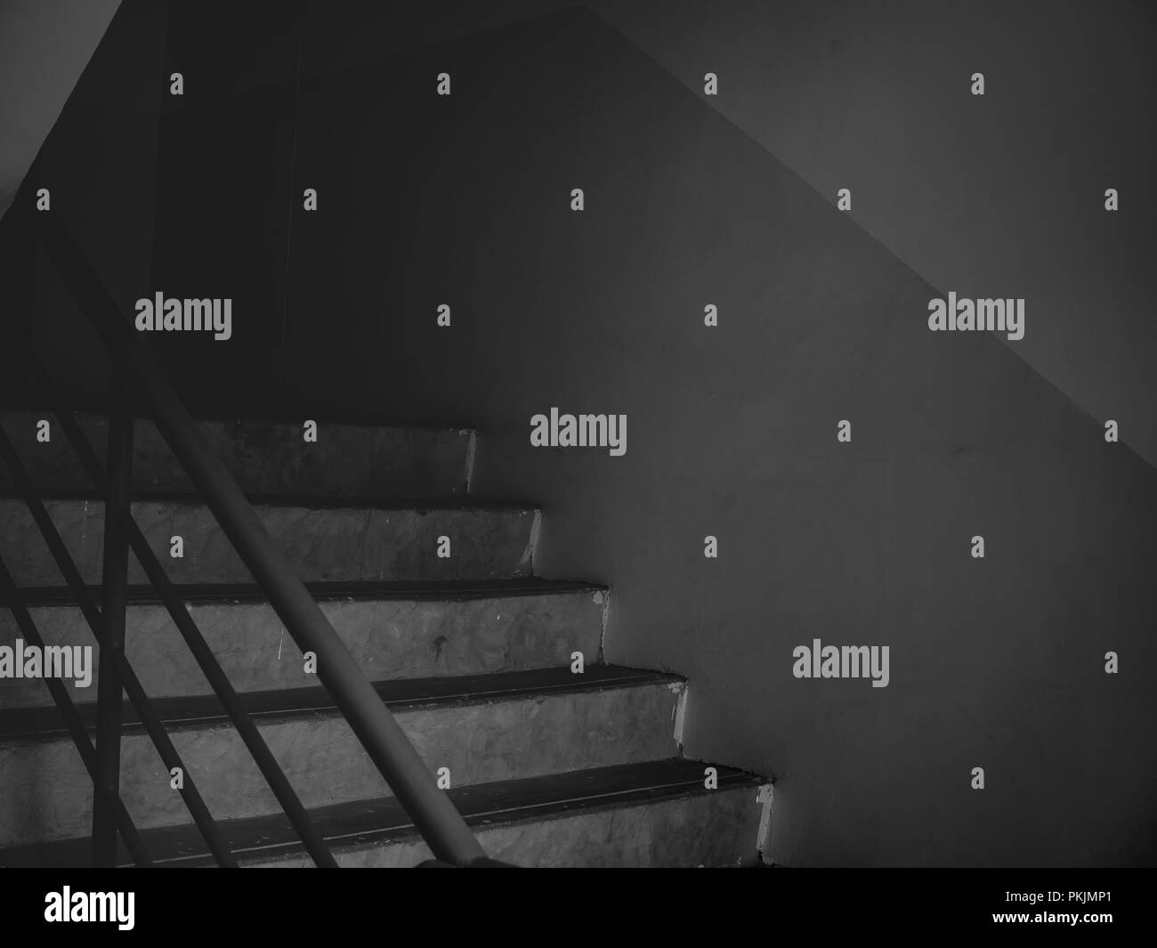 Dark mysterious cement stairs in lonely quiet building on black and ...