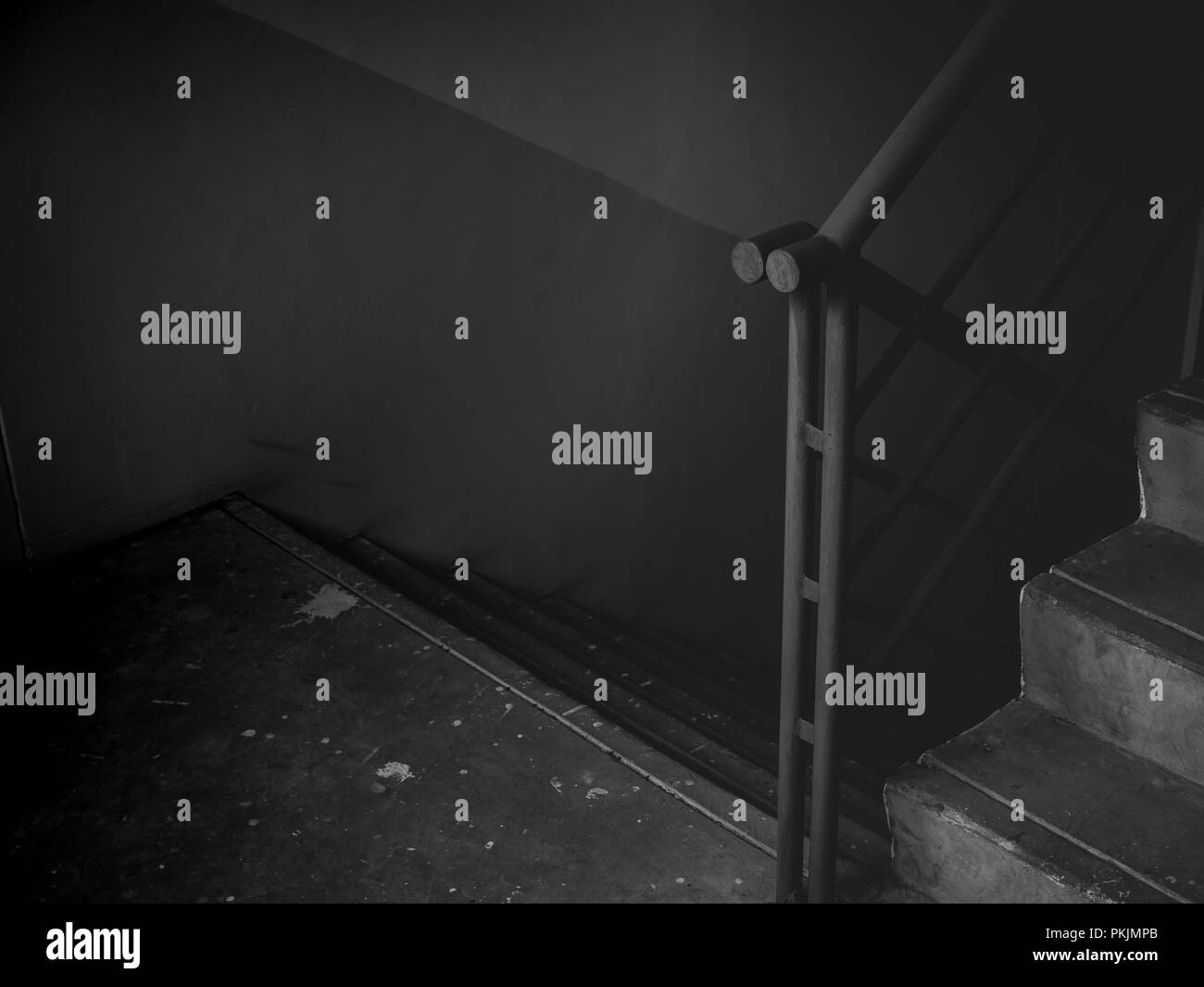 Dark mysterious cement stairs in lonely quiet building on black and ...