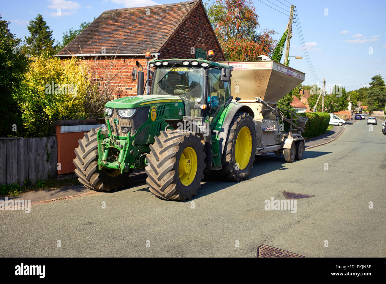 John Deere 6155R tractor and trailer parked in main street at Gnosall ...