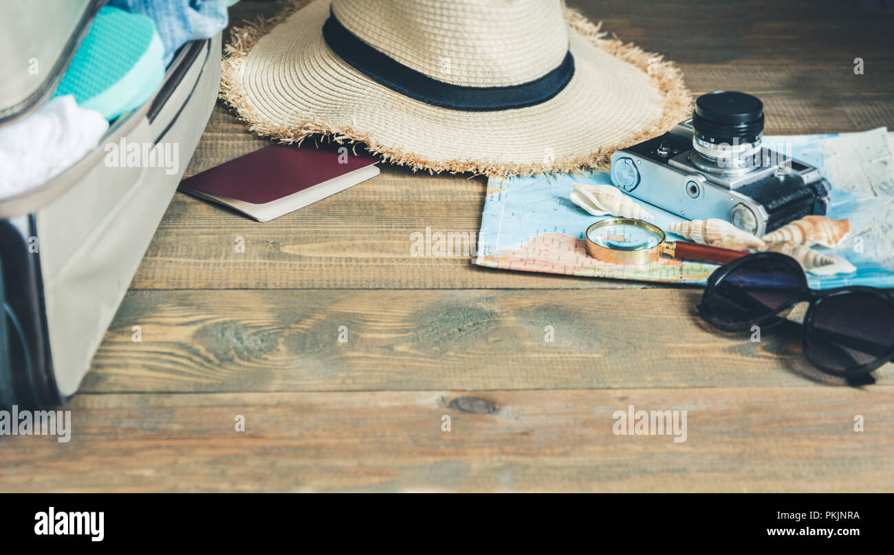 Open suitcase with female clothes for trip. Packing things Stock Photo ...